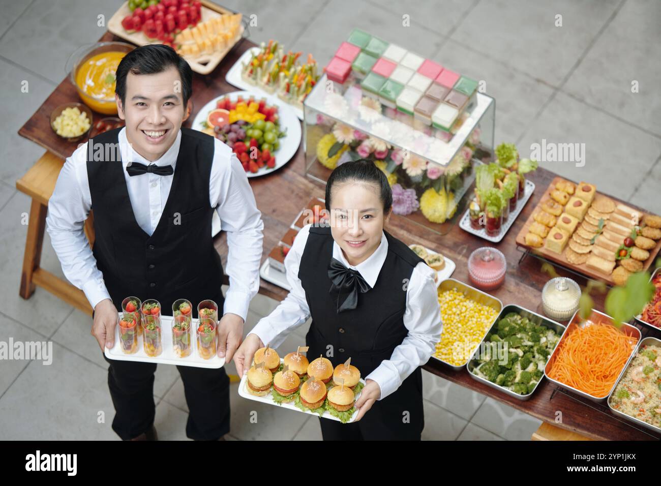 Smiling Chefs Presenting Plates of Appetizers Stock Photo - Alamy