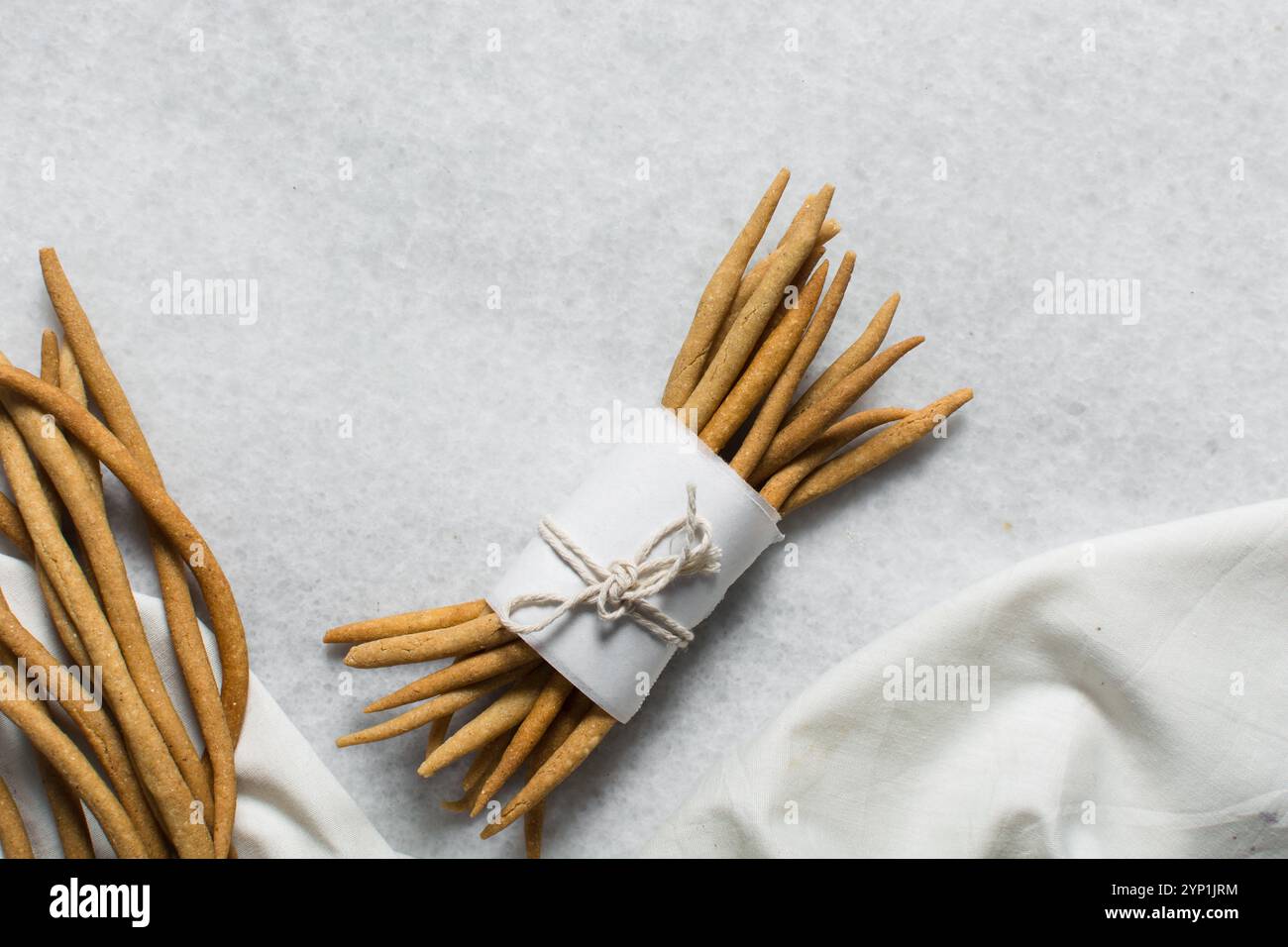 Top view of fried corn stick snack on a white granite countertop ...