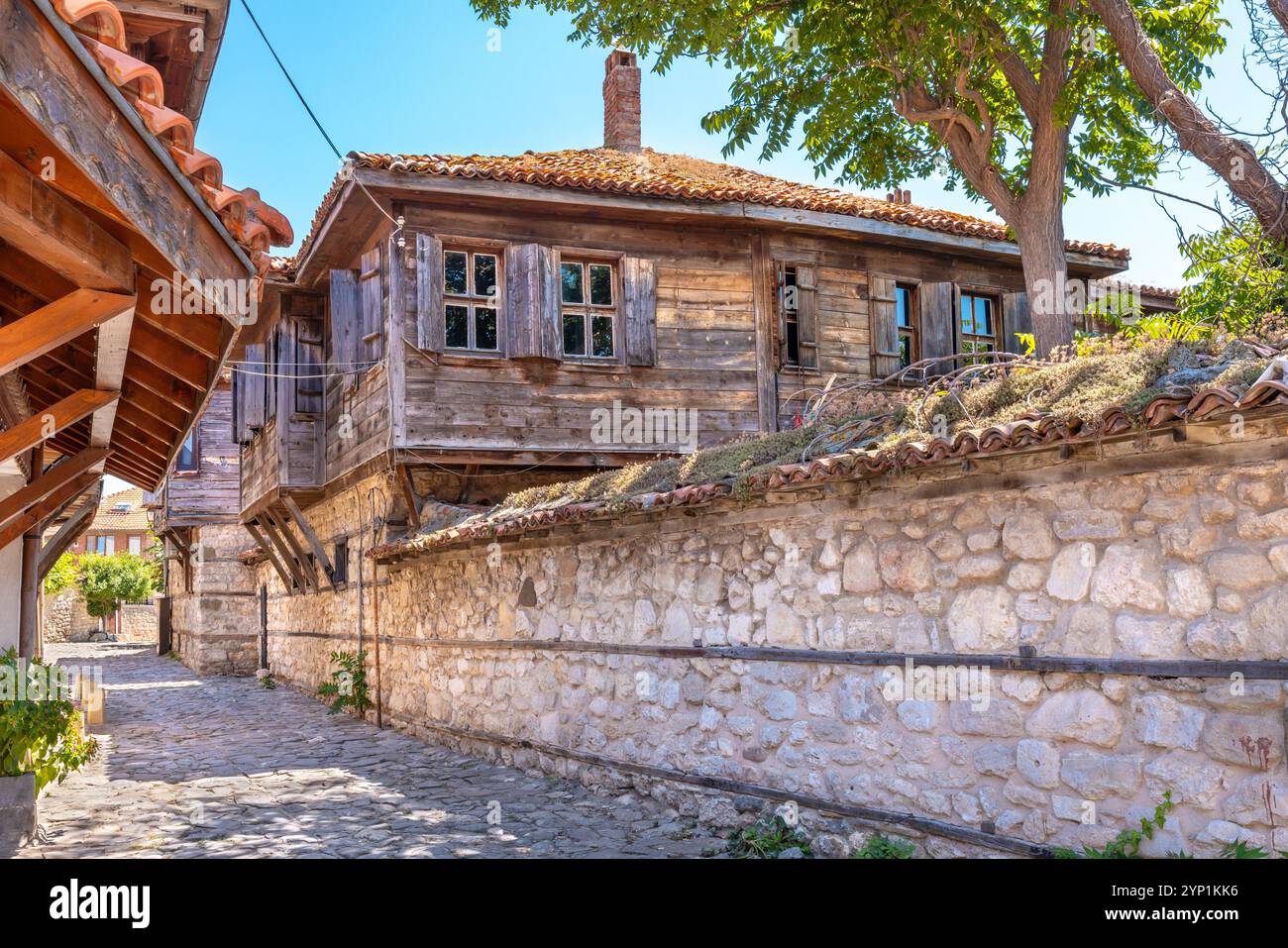 Traditional buildings on cobbled street in old town of Nessebar ...