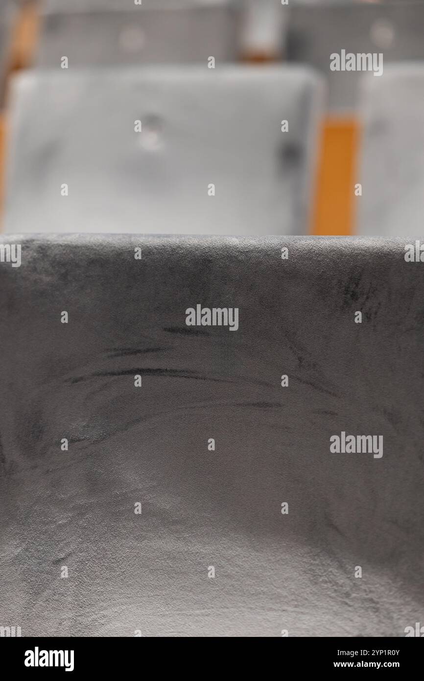 Rows of empty seats in a cinema hall, front side of the seats with ...