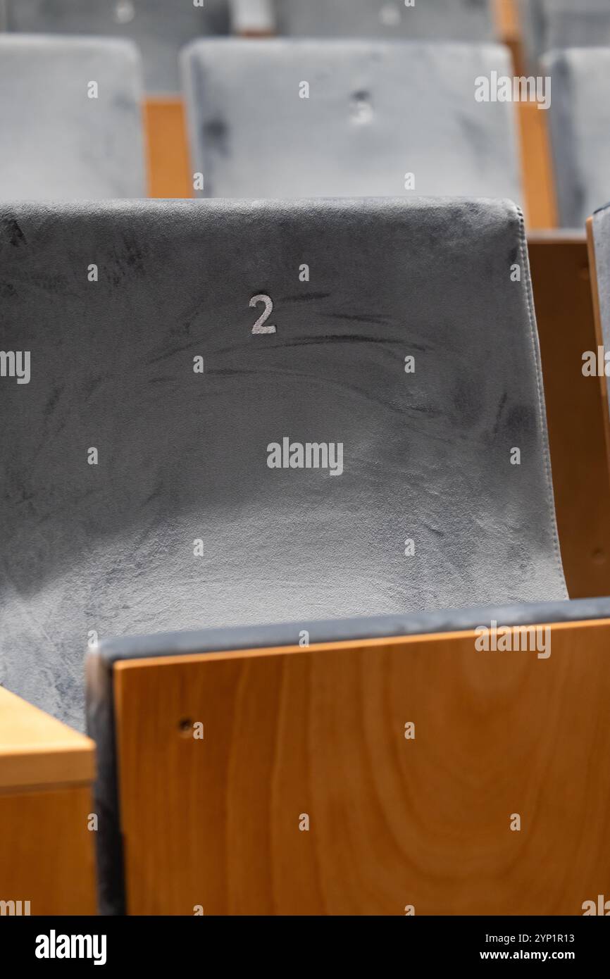 Rows of empty seats in a cinema hall, front side of the seats with ...