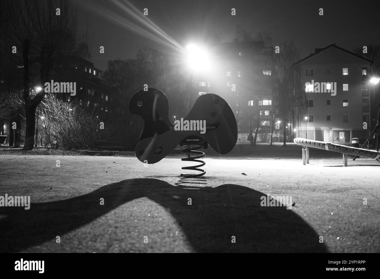 A swing in the playground during the night Stock Photo - Alamy