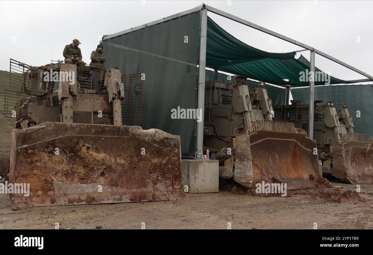 NORTHERN BORDER, ISRAEL - NOVEMBER 27: Israeli soldiers sit on top of a ...