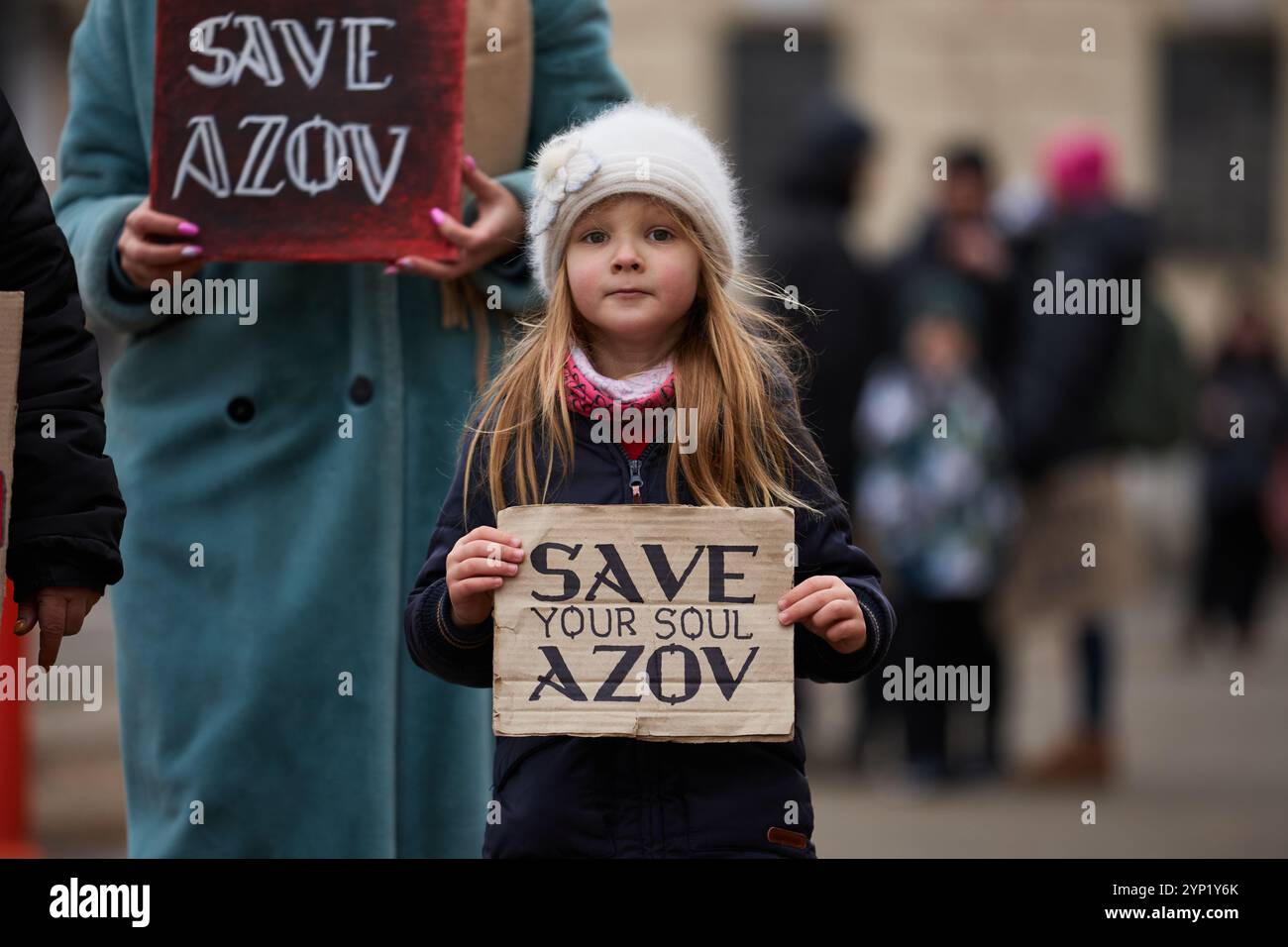 Little Ukrainian girl with a poster Save Azov at a public demonstration ...