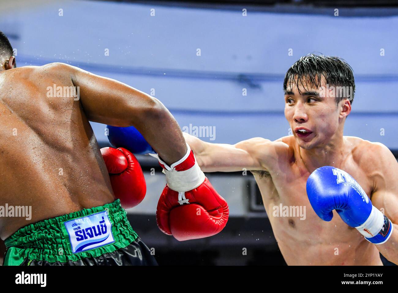 Yangyang Li (R) and Phongthep Homjui (L) seen in action during their WBA Asia 140-pound title at ...
