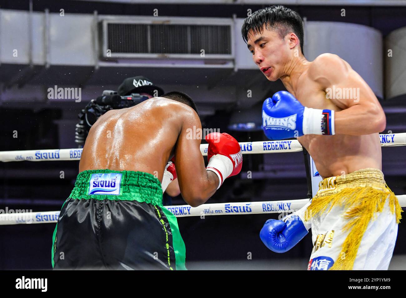 Yangyang Li (R) and Phongthep Homjui (L) seen in action during their WBA Asia 140-pound title at ...