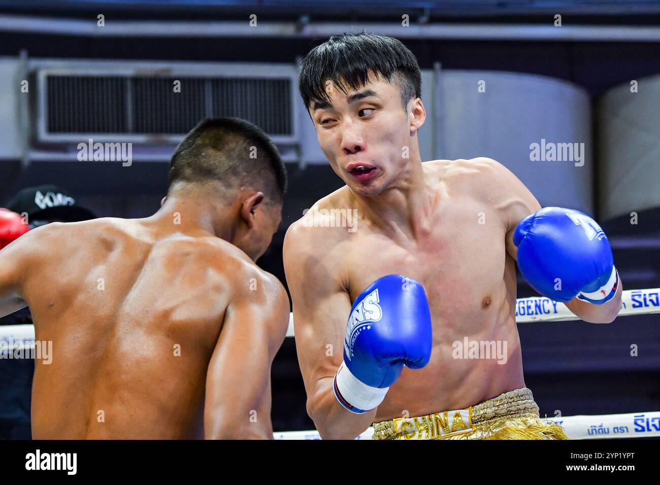 Yangyang Li (R) and Phongthep Homjui (L) seen in action during their WBA Asia 140-pound title at ...