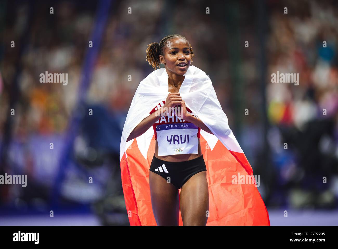 Winfred Yavi celebrating her medal with her country's flag at the Paris ...