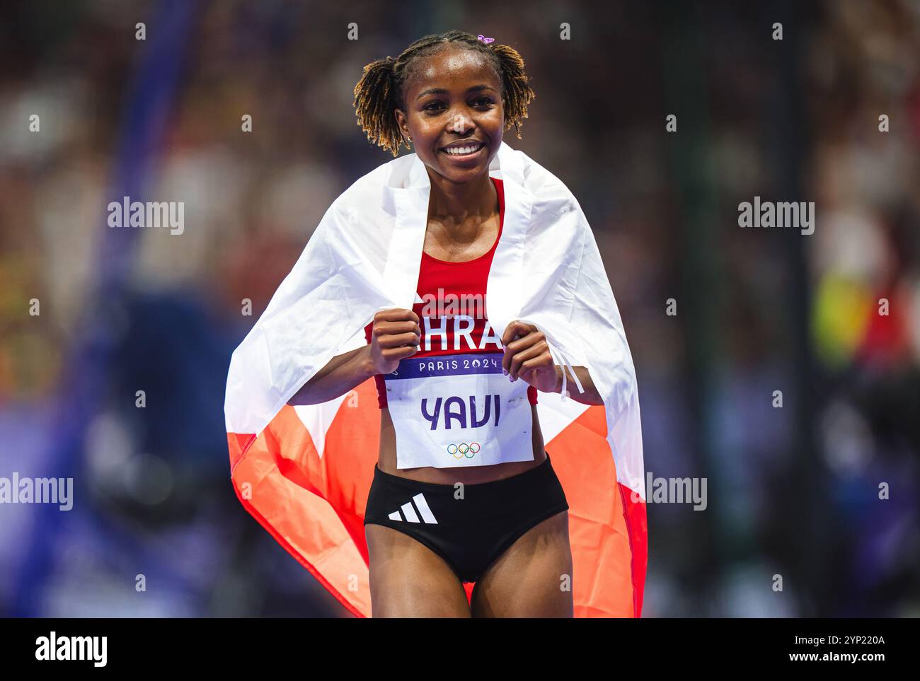Winfred Yavi celebrating her medal with her country's flag at the Paris ...