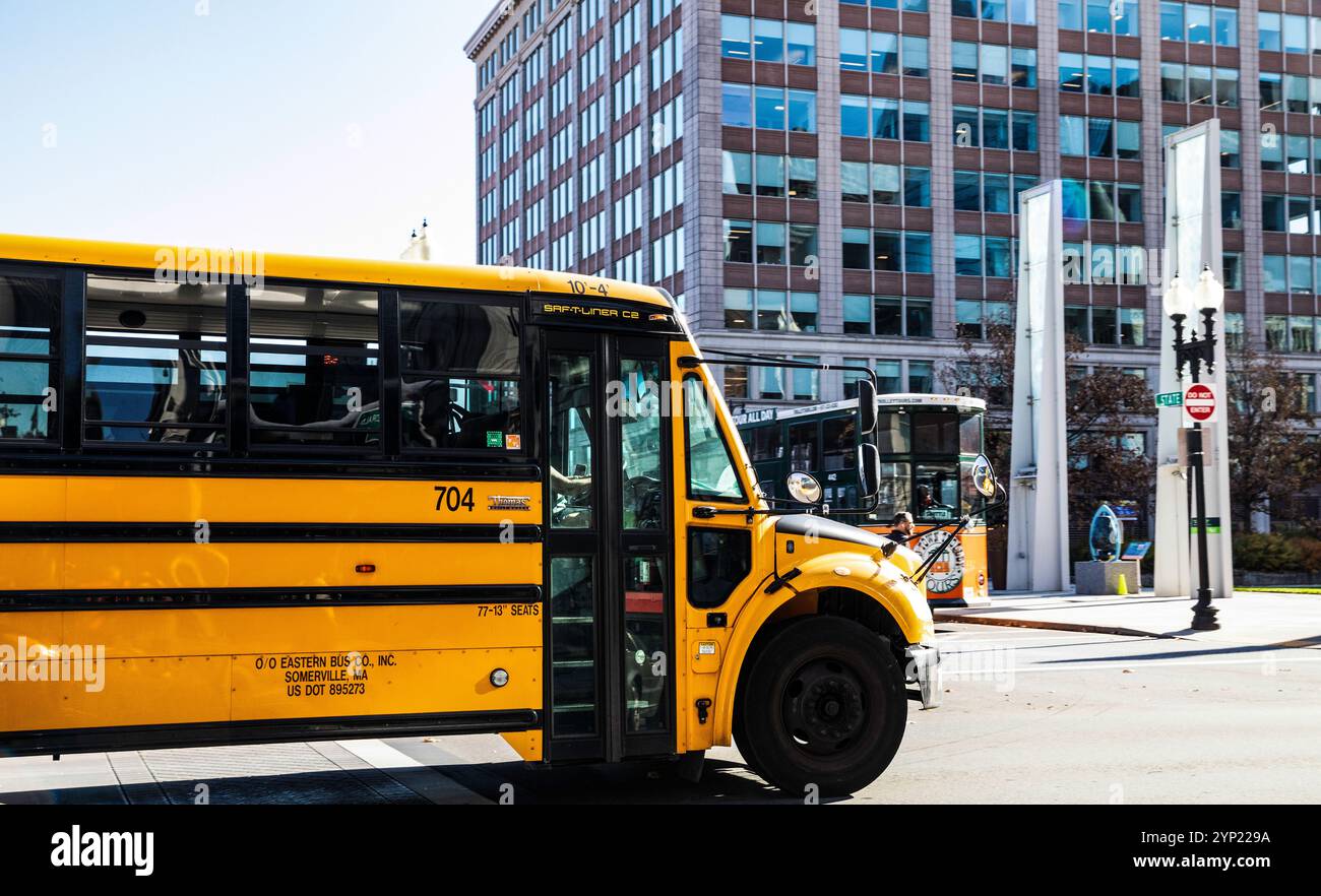 School bus passes in front of a trolley bus in Boston USA Stock Photo ...
