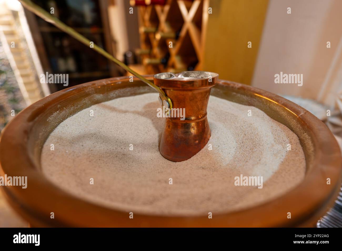 Turkish coffee prepared in sand with turk. making coffee on hot sand ...