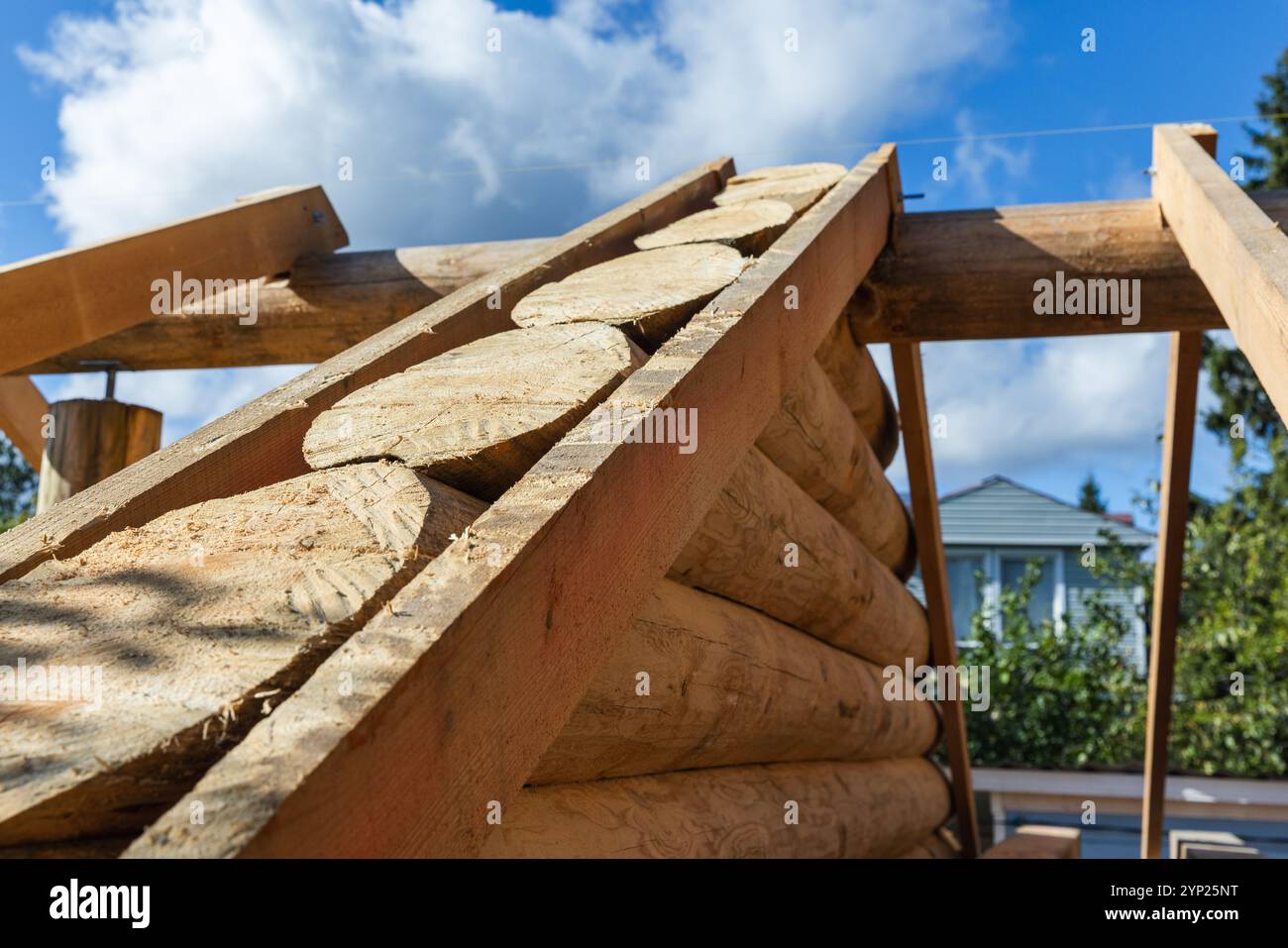 Wooden roof details, a log house is under construction. Background ...