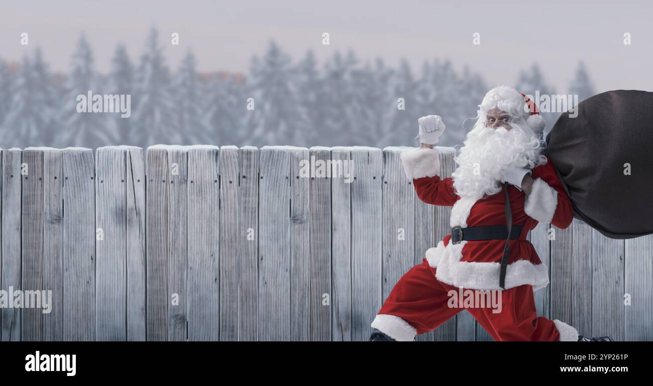Fast Santa Claus running and carrying a sack with Christmas gifts ...