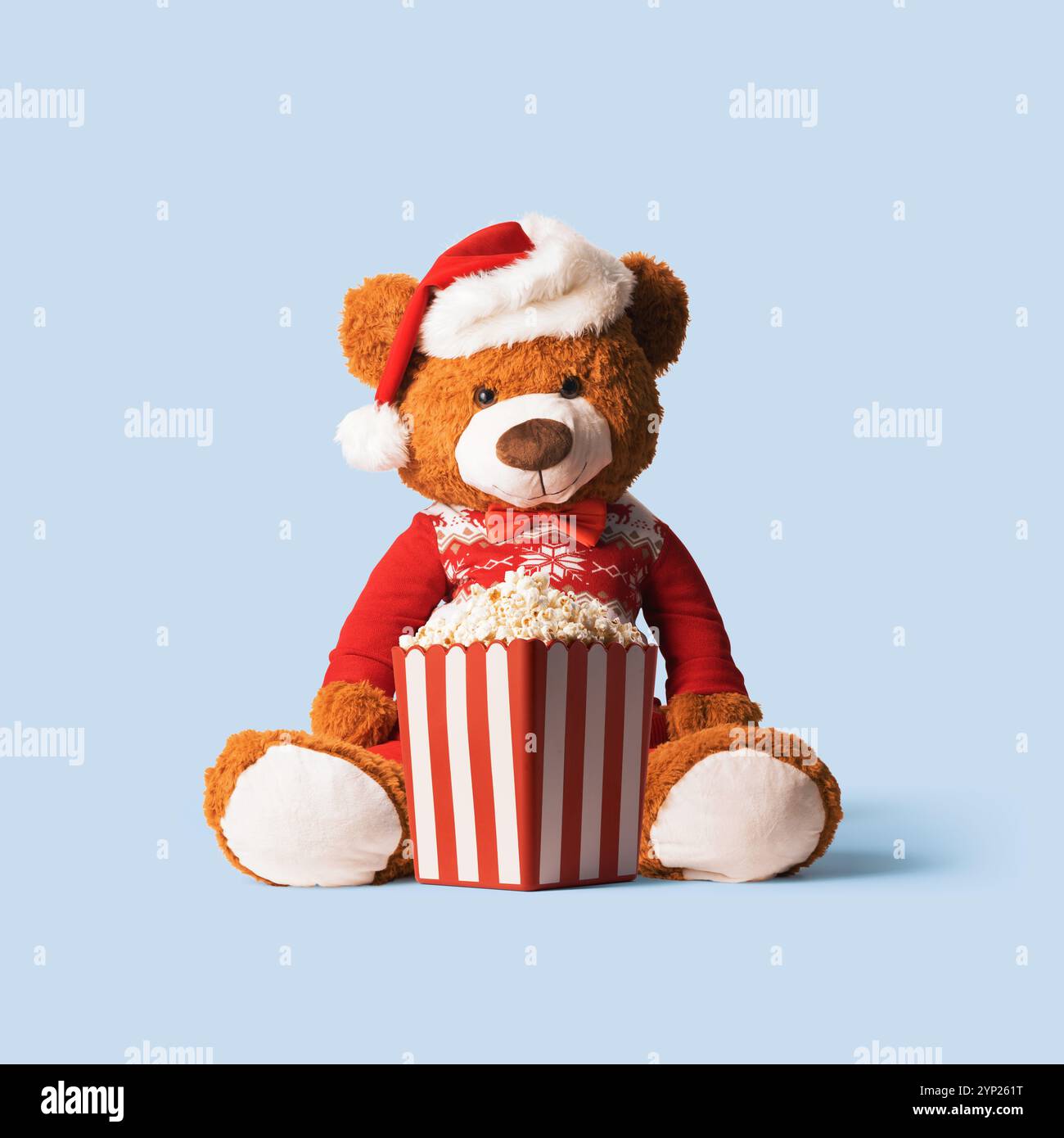 Cute teddy bear watching Christmas movies on TV and eating popcorn ...