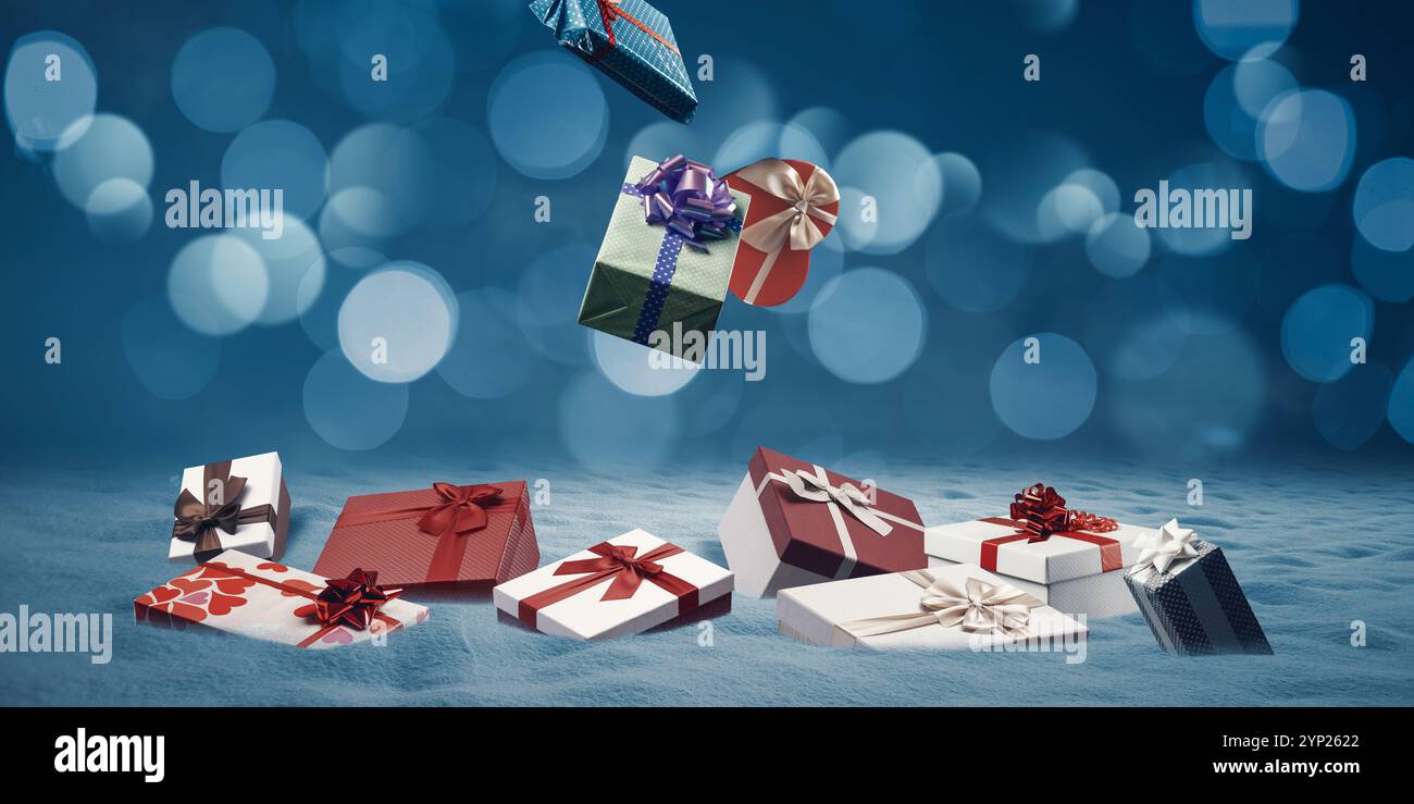 Many Christmas gifts falling from the sky on the snow, holidays and ...