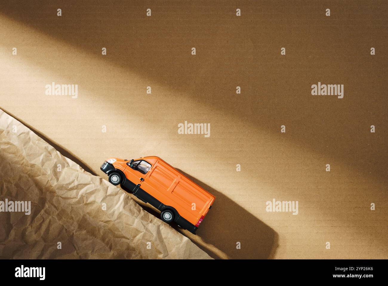 Cute toy delivery van on cardboard landscape background, delivery ...