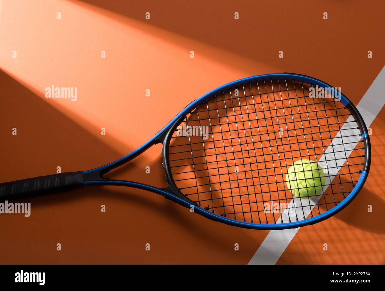 Racket and ball on the tennis court floor and beam of sunlight, sports ...