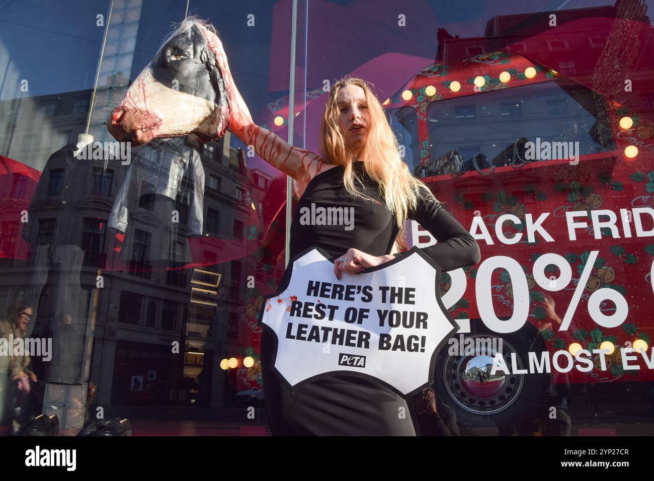 London, UK. 28th November 2024. A PETA activist stands outside the ...