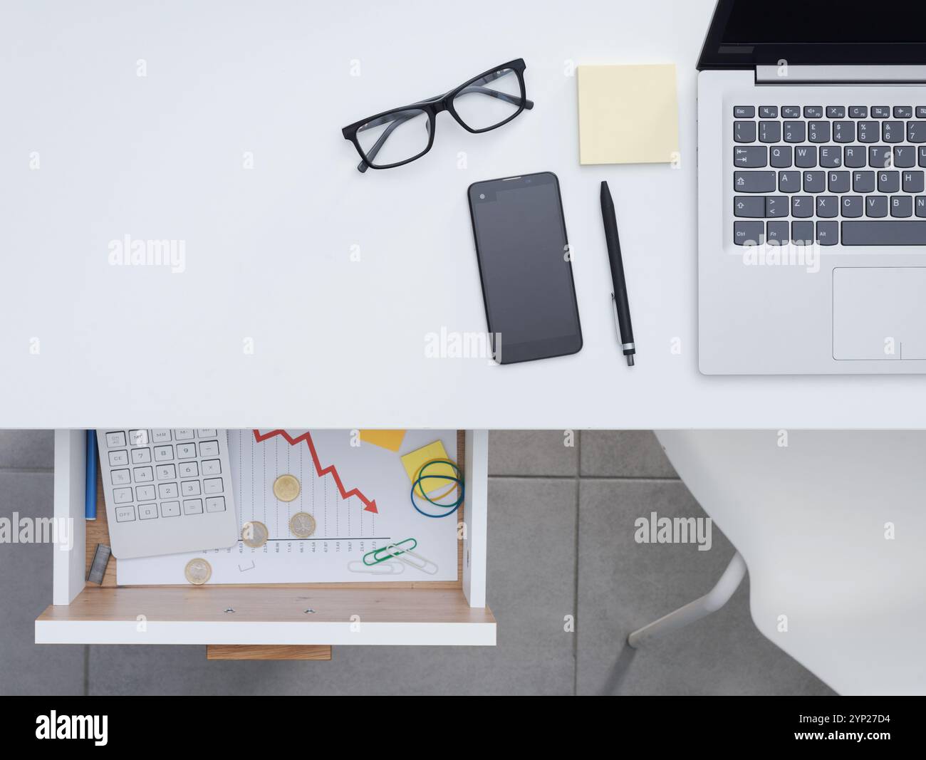 Corporate business desk with open drawer containing hidden financial ...