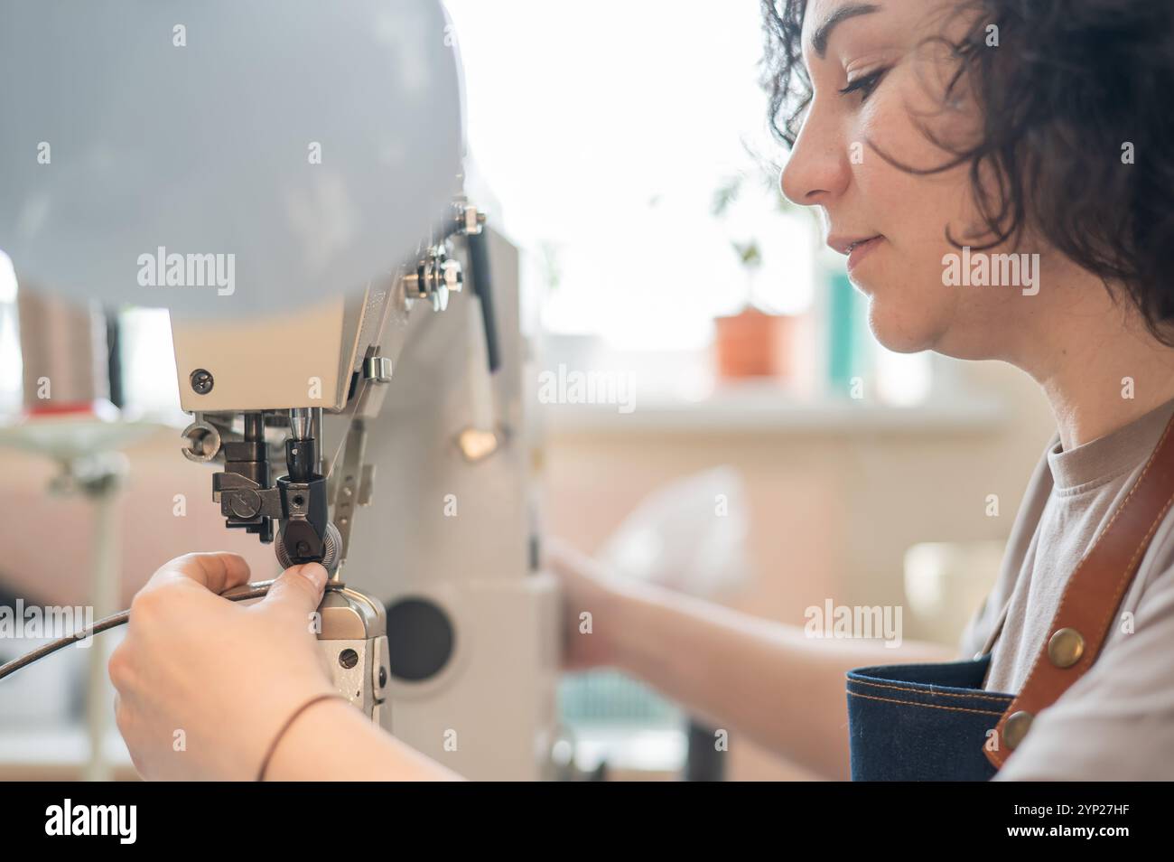 Woman tanner sews leather hi-res stock photography and images - Alamy