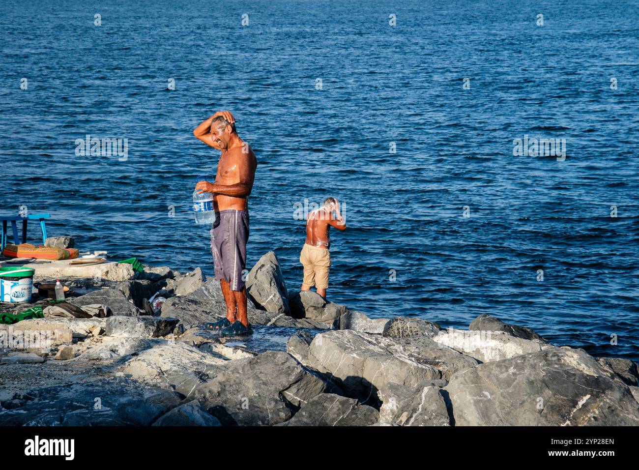 Turkish men washing off salt water after an evening swim in the ...