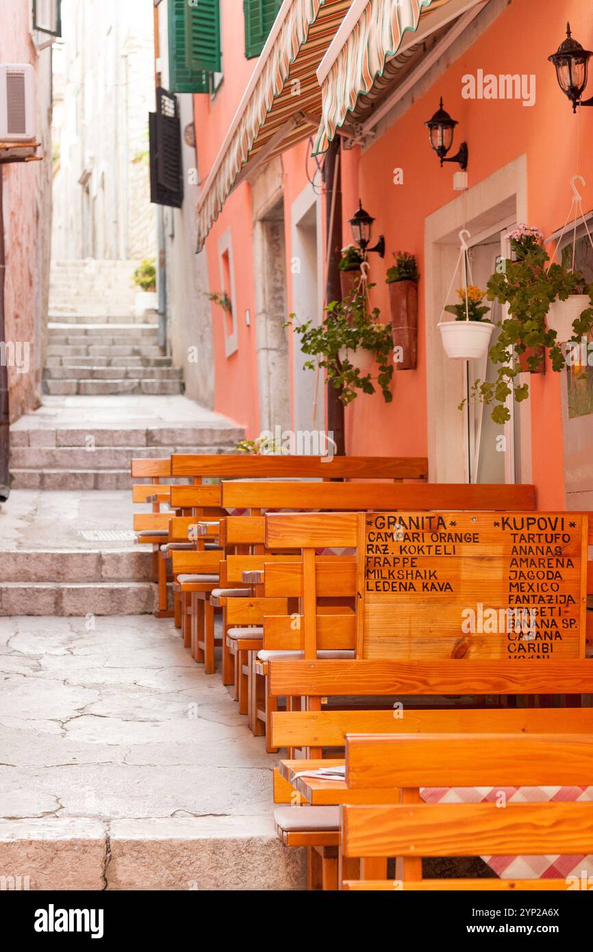 Typical outdoor restaurant with lunch menu on the steps of narrow ...