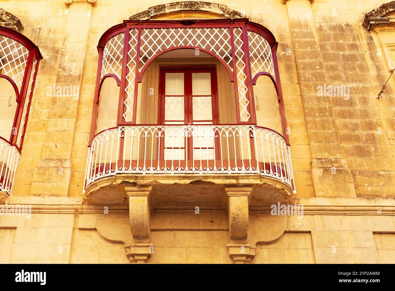Traditional Maltese balconies on the stone wall of historic house in ...
