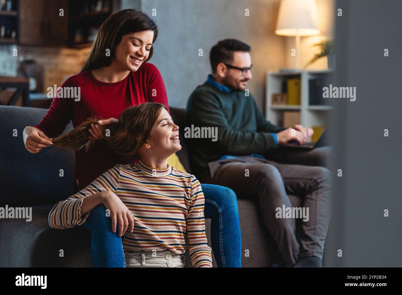 Happy parents, teen daughter having pleasant conversation, laughing ...
