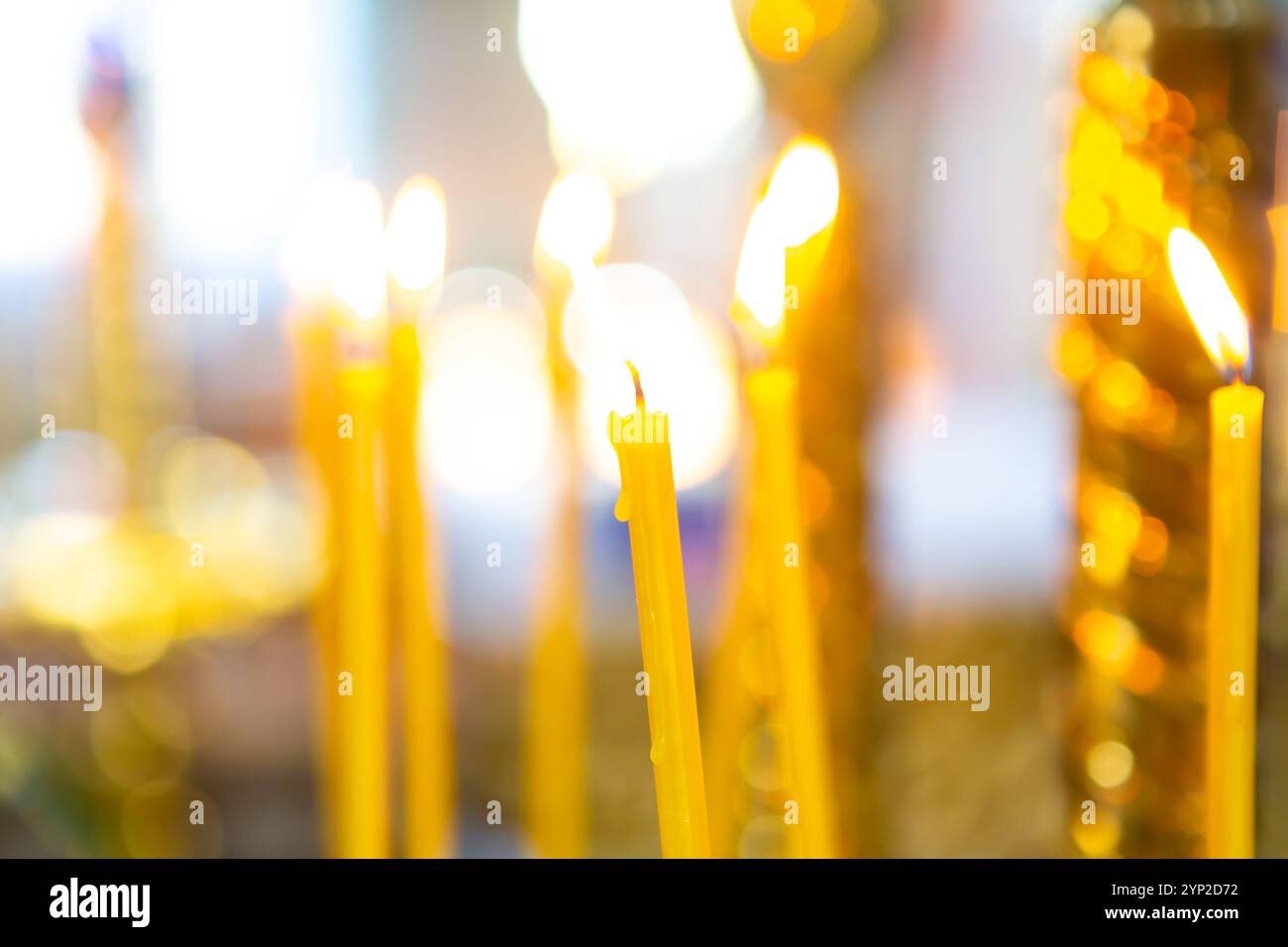 Burning wax candles in a Buddhist temple close-up. Rituals of worship ...