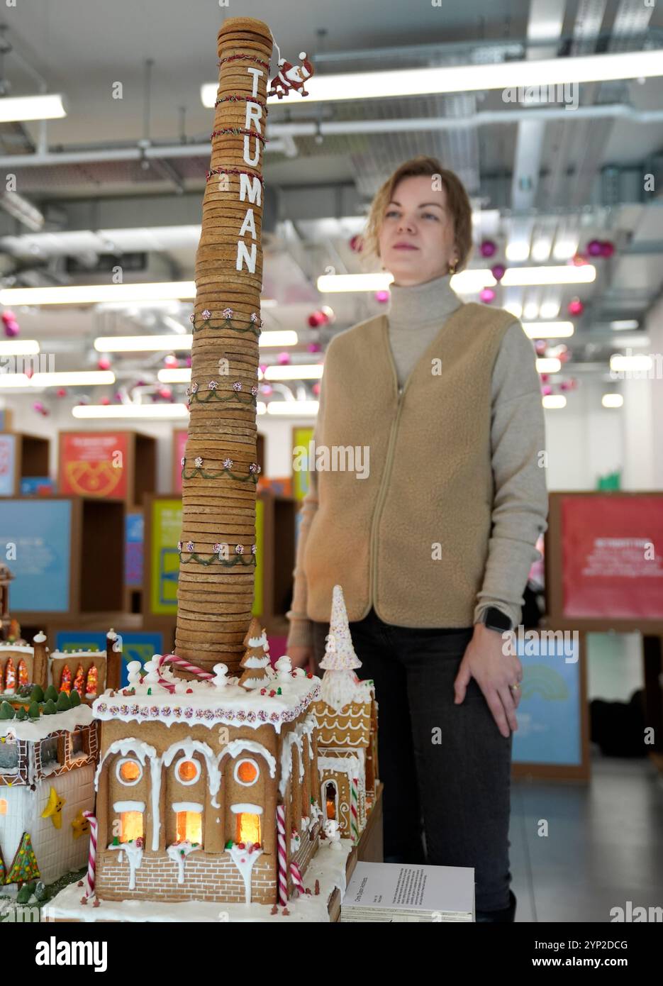 A person looks at a gingerbread model of Truman Brewery, which forms ...