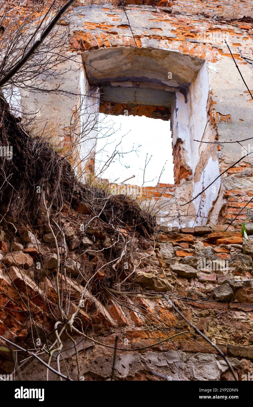 The old ruins of the collapsed walls with gates and windows ...