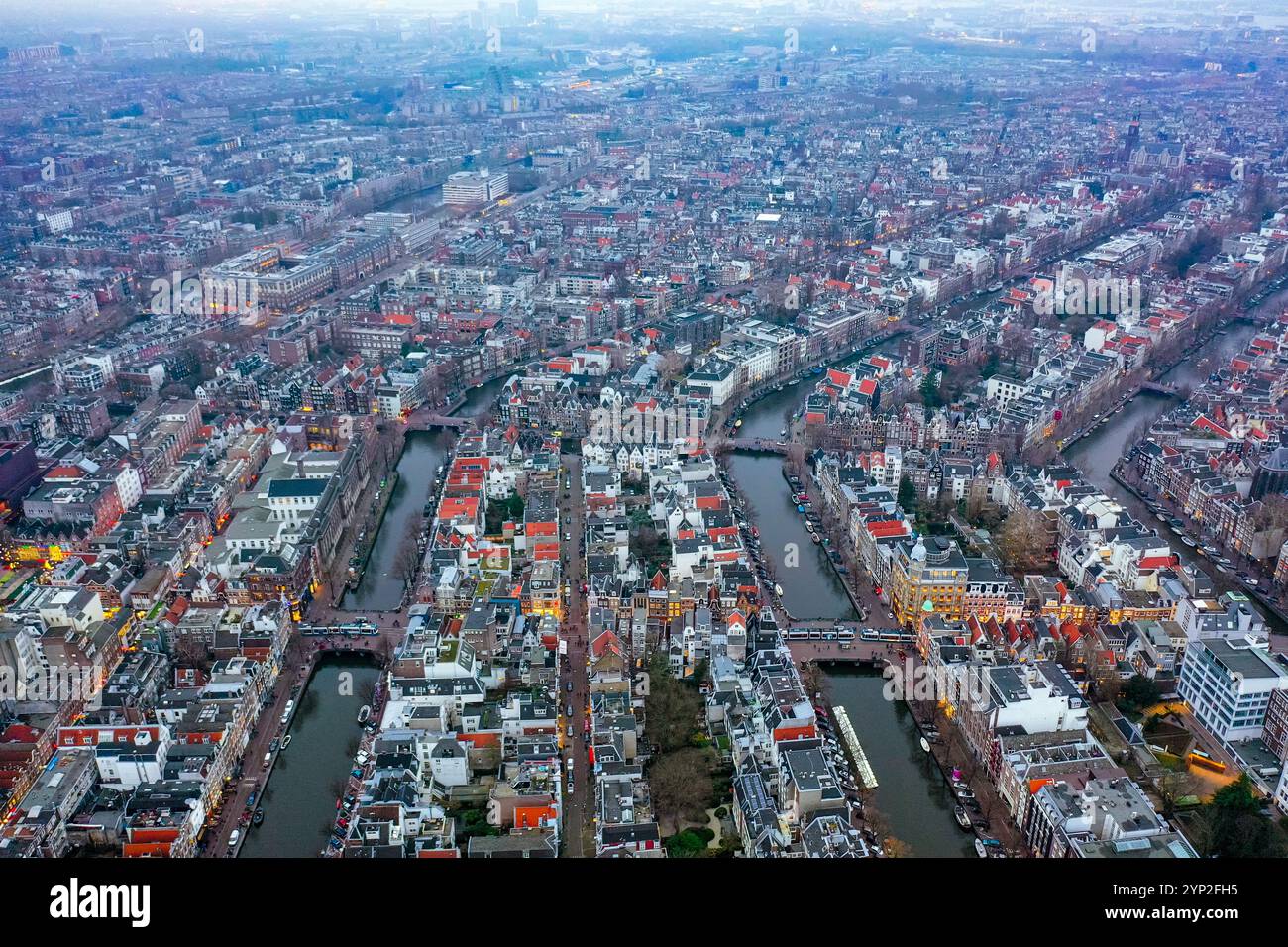 Aerial view of Amsterdam's iconic canal district at twilight ...
