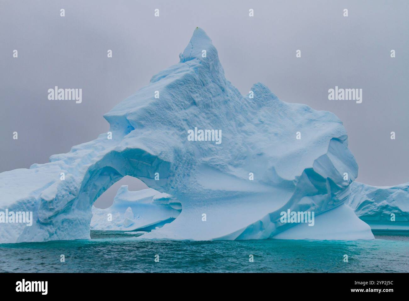 Unusual window formation in iceberg showing Booth Island in the ...