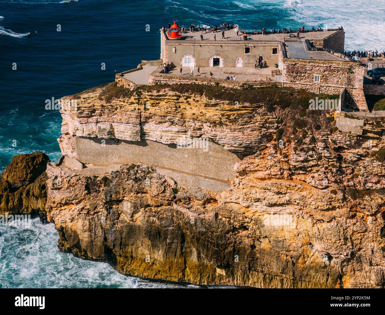 Aerial view of tourists at the historic Sao Miguel Arcanjo lighthouse ...