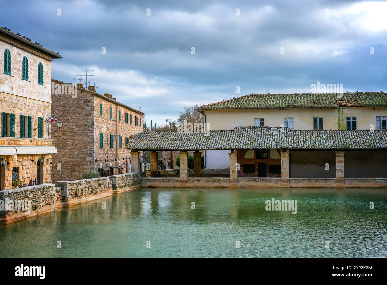 Bagno Vignoni hot springs pool with traditional Tuscan buildings ...