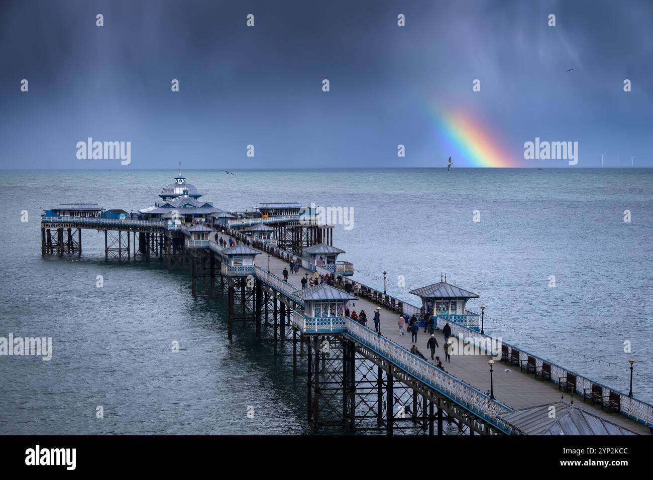 Rainbow and moody skies over llandudno pier hi-res stock photography ...