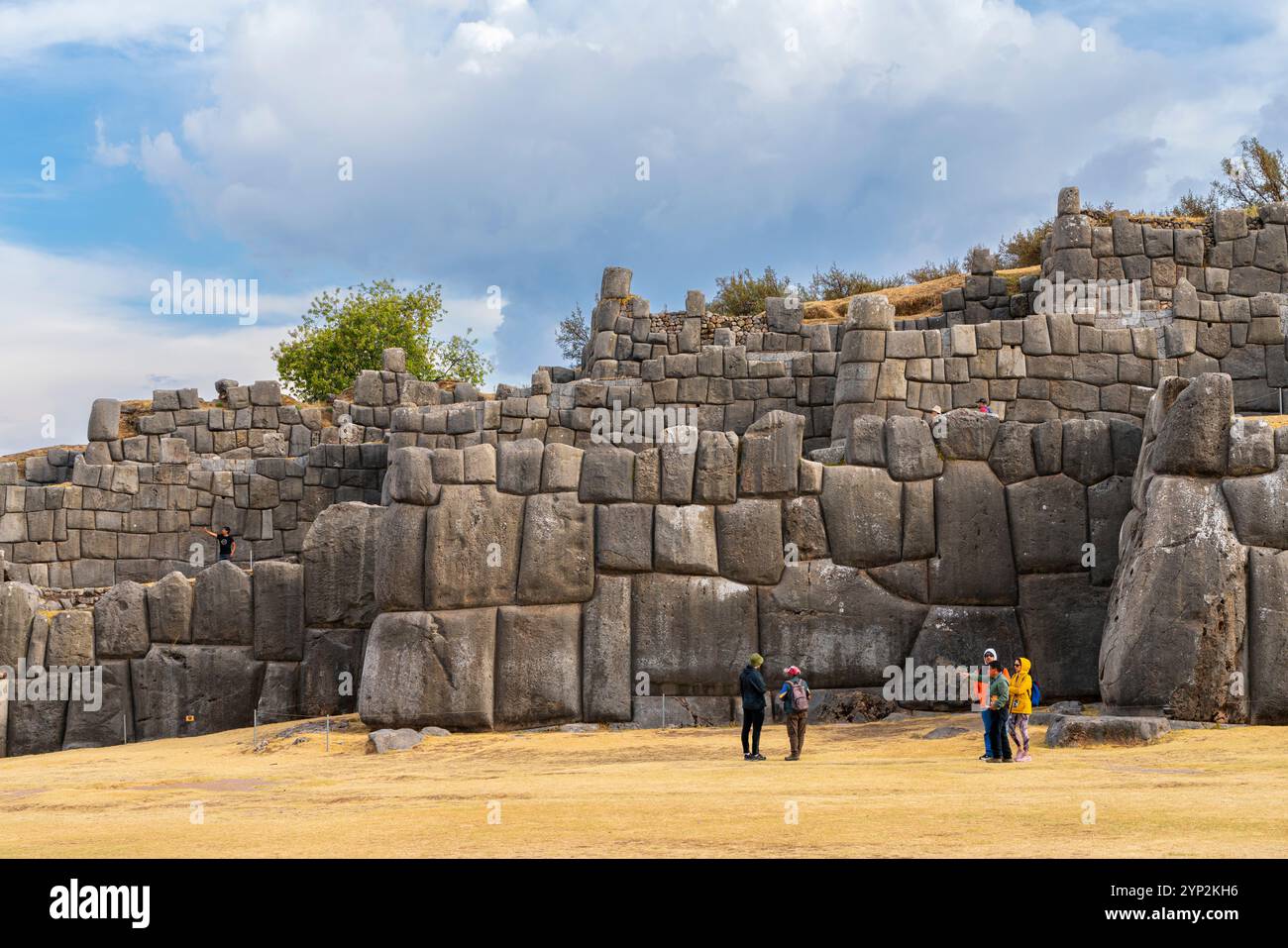 Tourists at stone wall at archaeological site of Sacsayhuaman, UNESCO ...