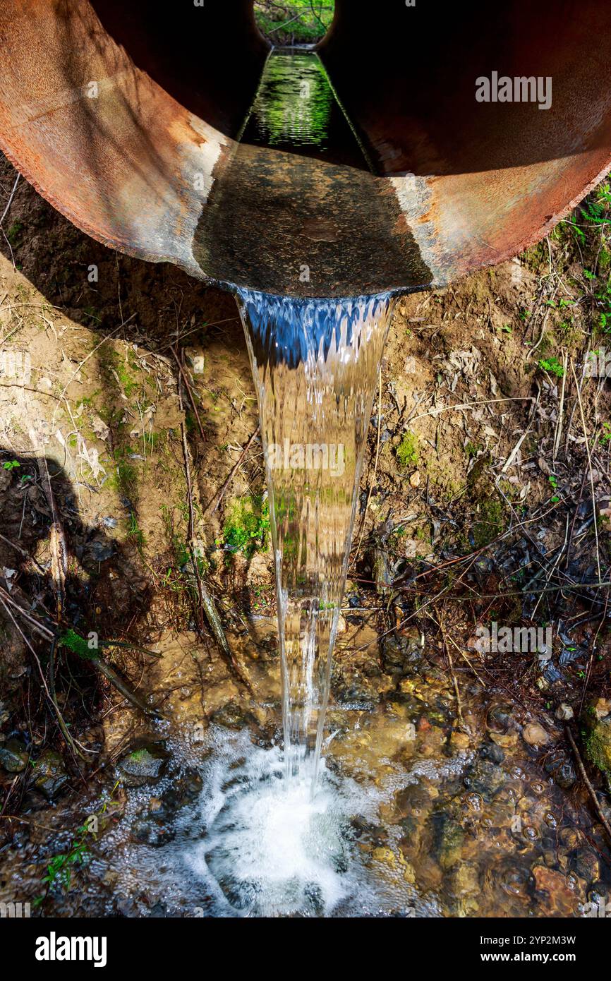 Water falling into a stream from a culvert Stock Photo - Alamy