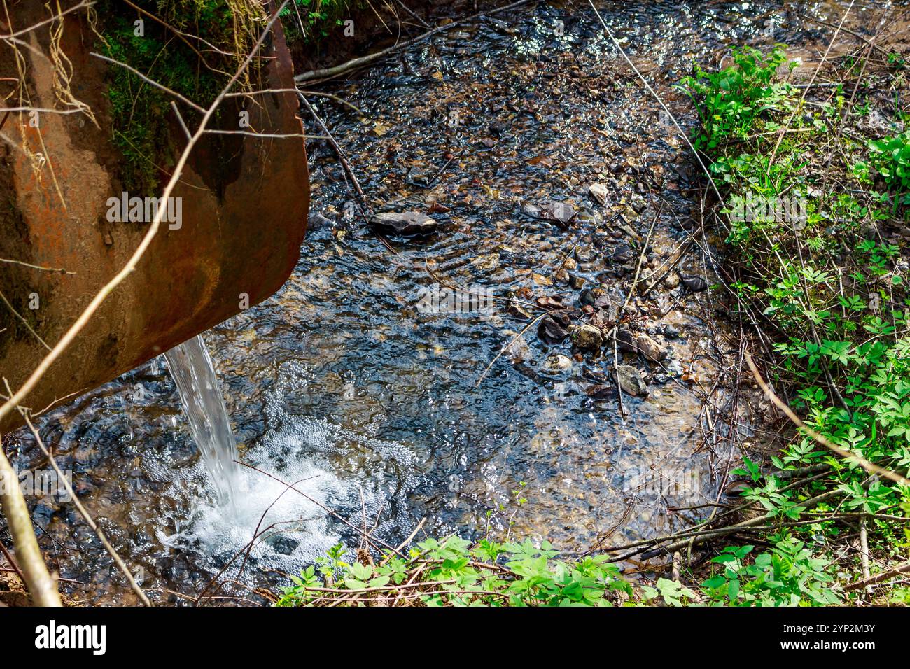 Water falling into a stream from a culvert Stock Photo - Alamy