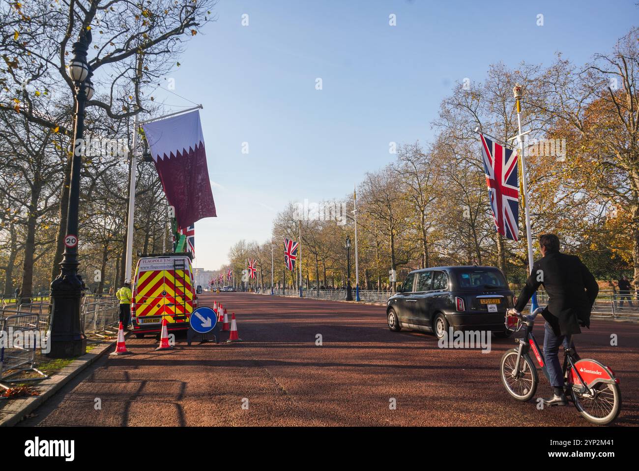 London, UK. 28 November 2024 Flag engineers on a cherry picker hang the ...