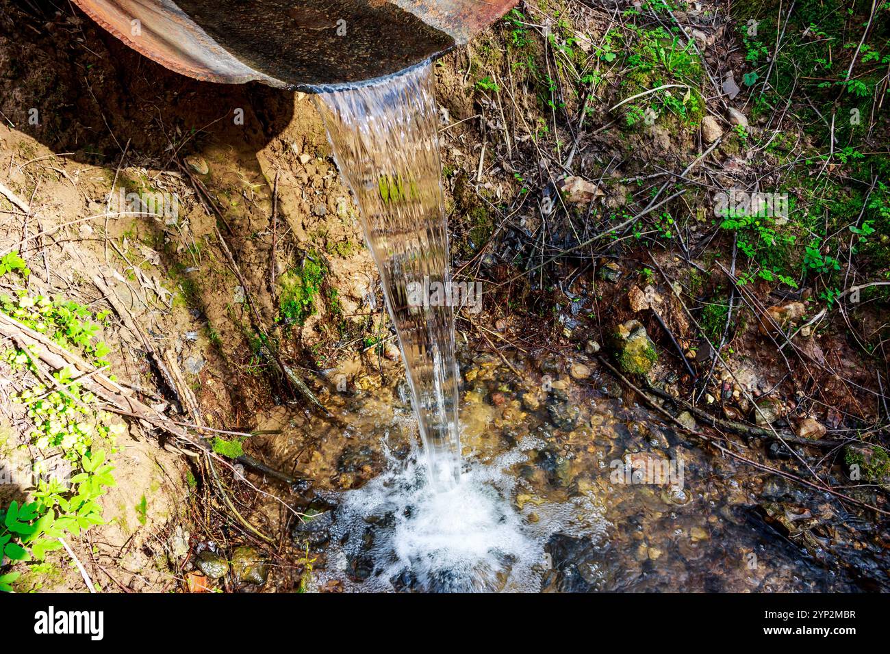 Water falling into a stream from a culvert Stock Photo - Alamy