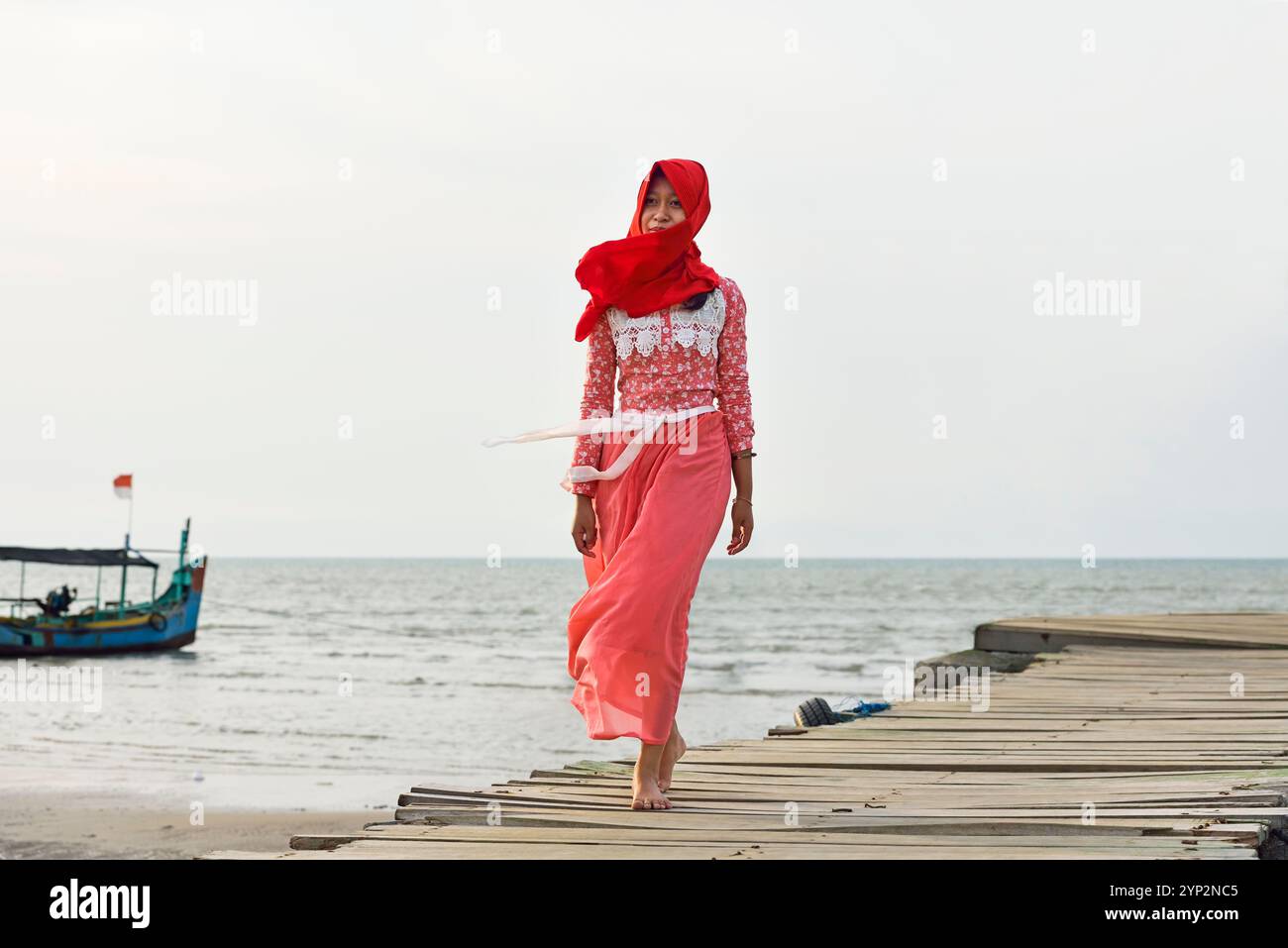 Young woman walking on a pontoon at Karangjahe Beach near Lasem, Java ...