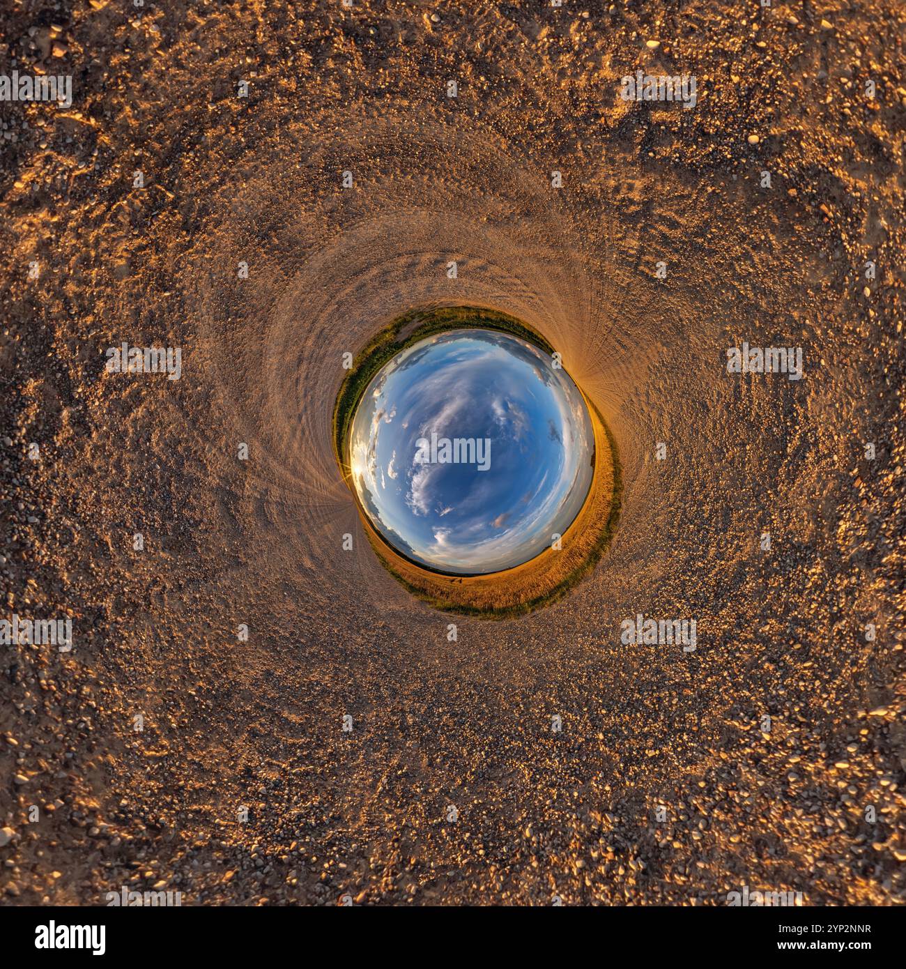 blue hole sphere or globe little planet inside green dry grass or stone ...