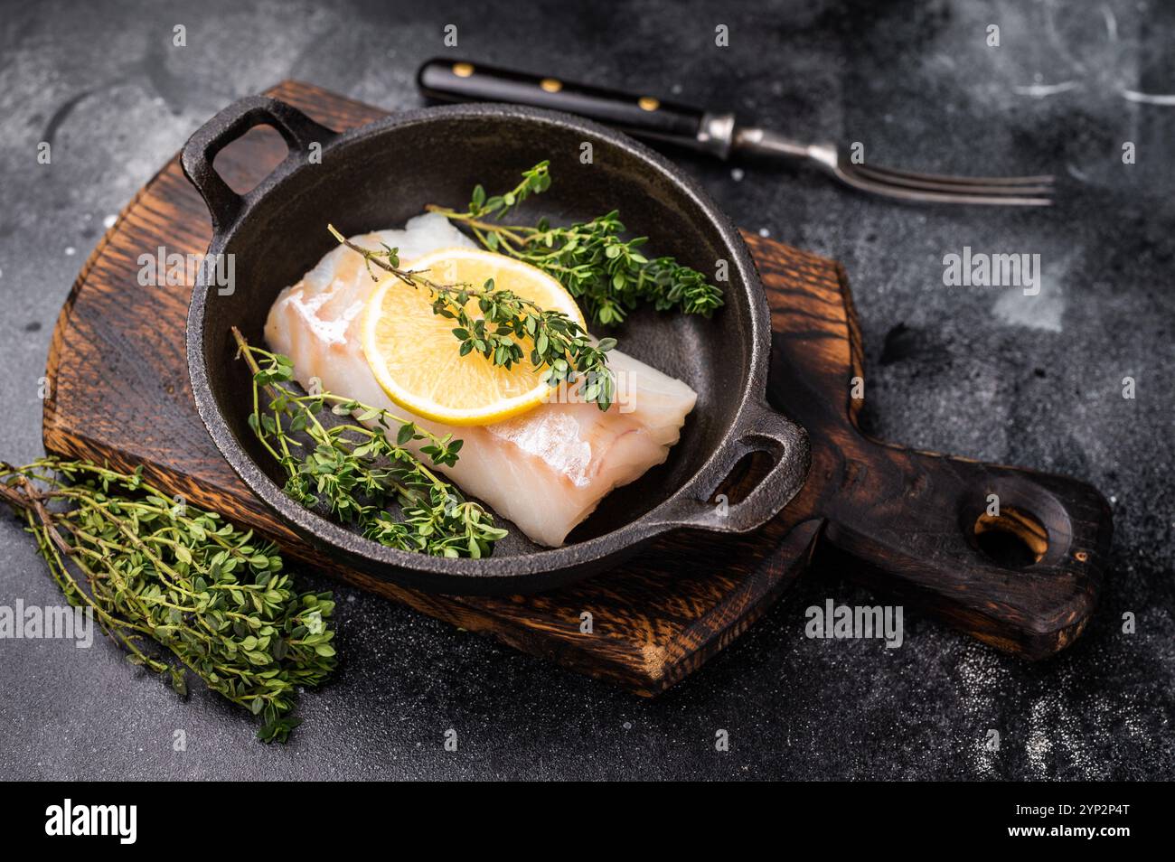 Raw cod fish fillets, whitefish without skin in skillet. black ...
