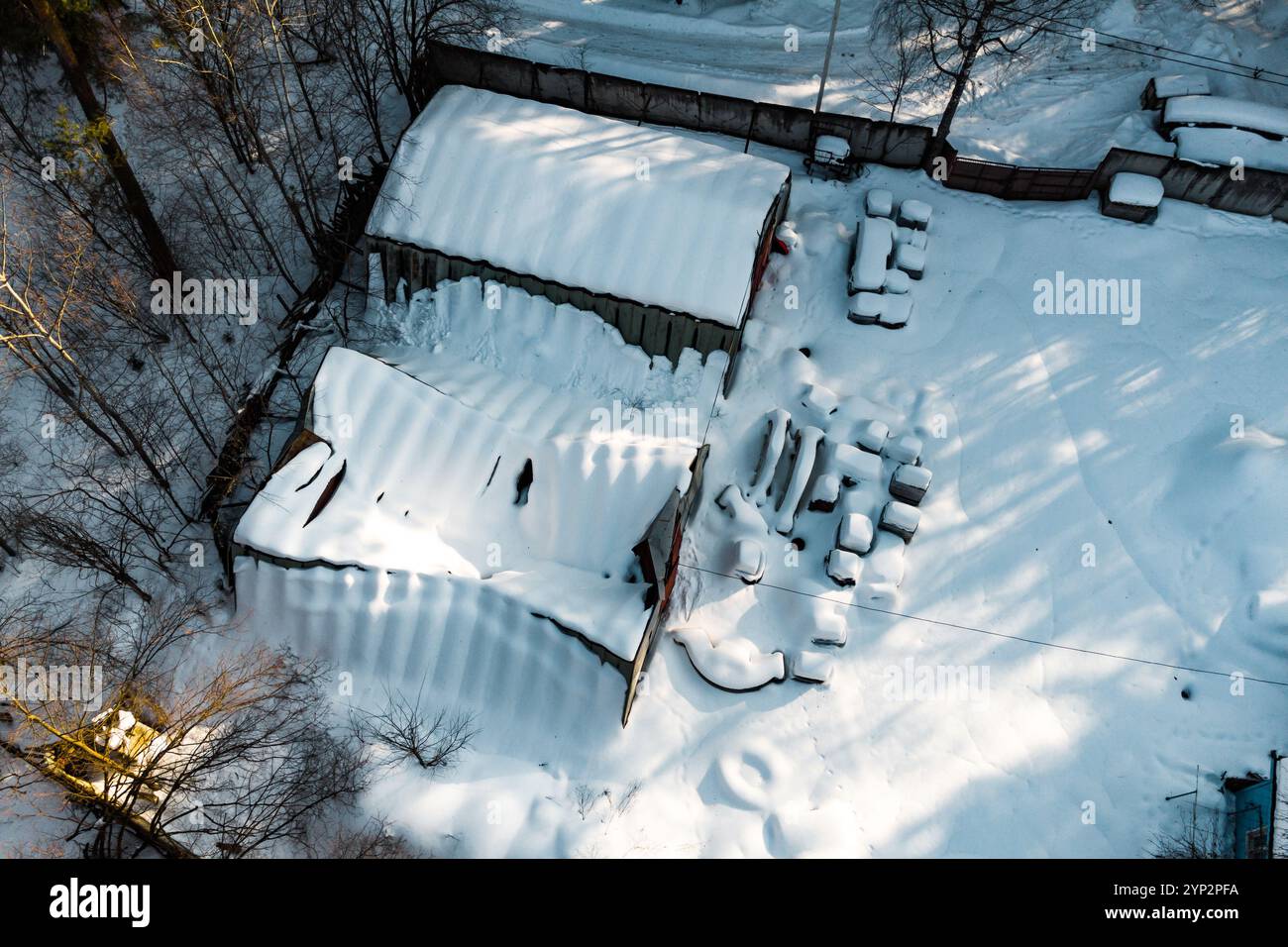 Top view of collapsed hangar roof under the weight of snow, abandoned ...