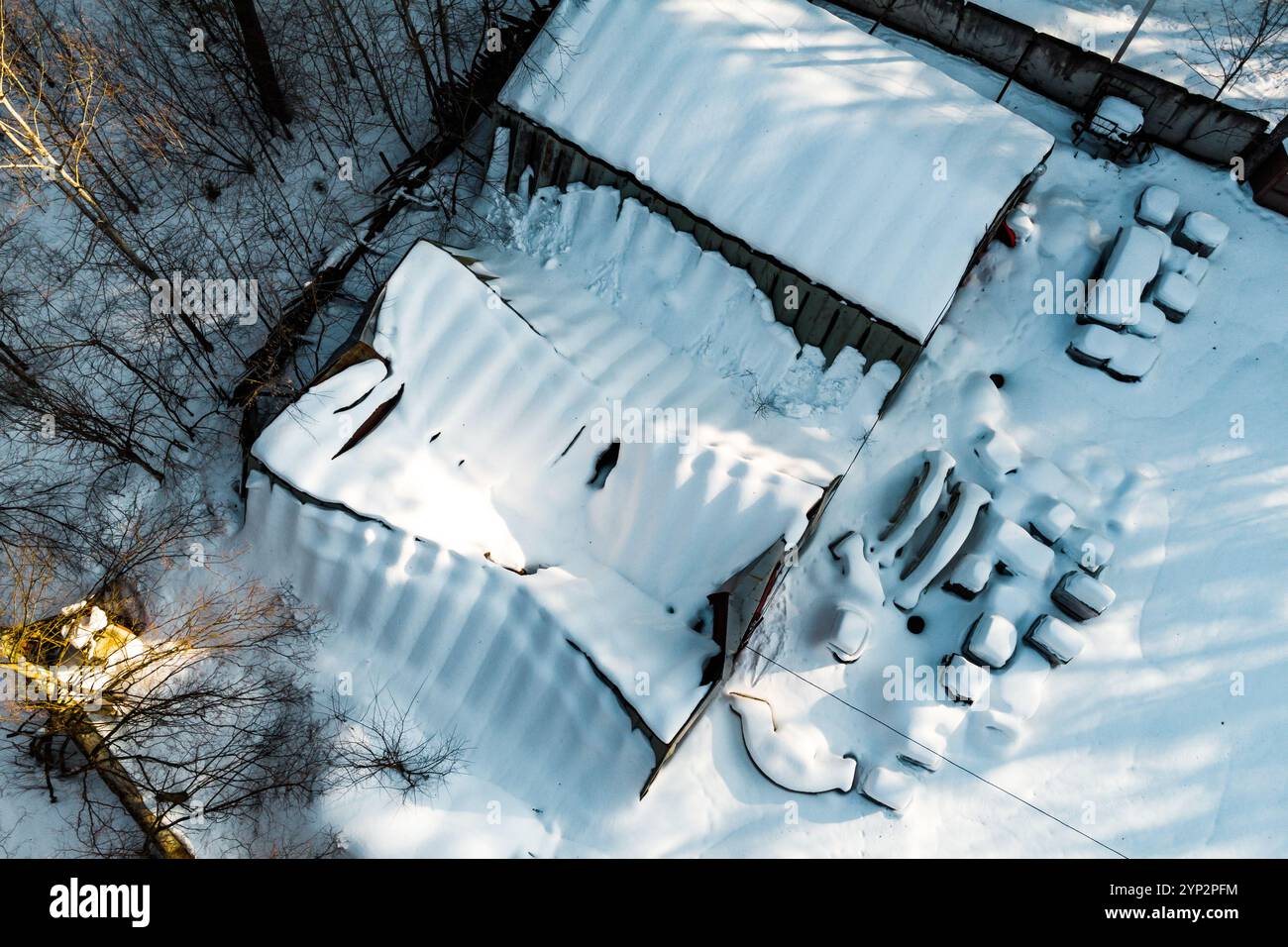 Top view of collapsed hangar roof under the weight of snow, abandoned ...