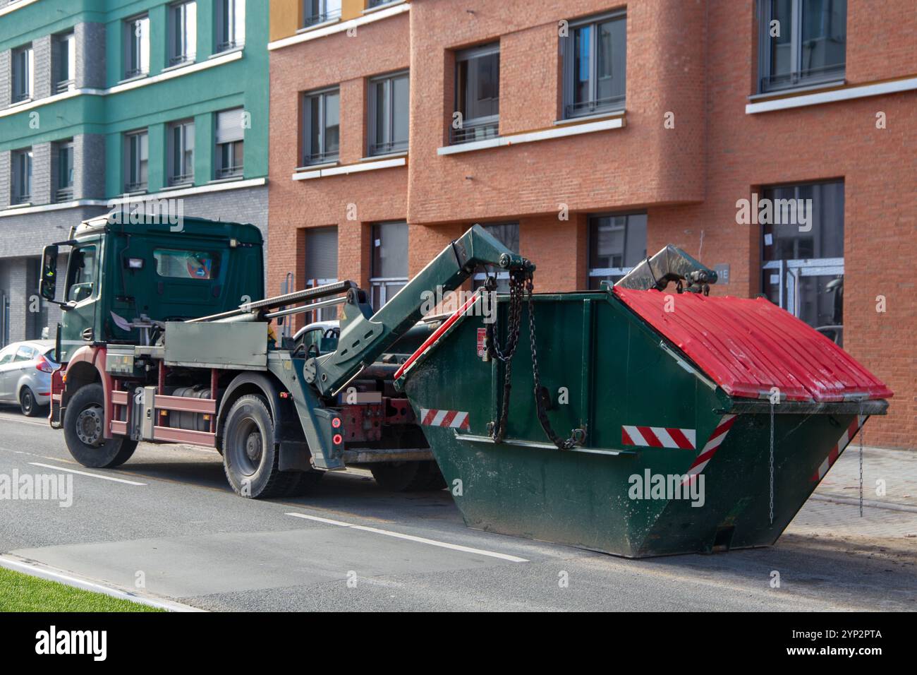 Container service: Lorry with skip container in front of a new ...