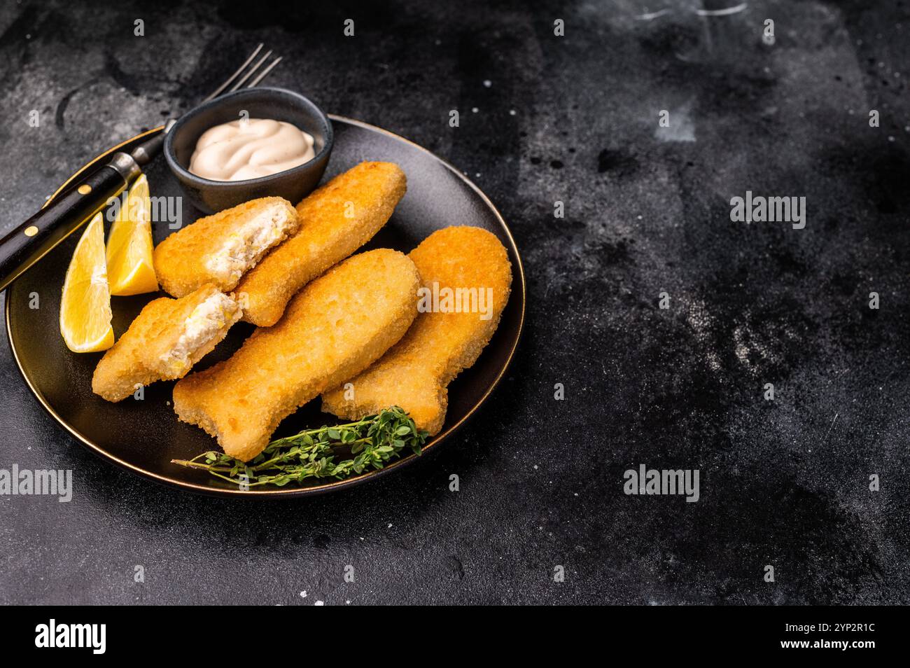 Crispy fried cod Fish sticks on plate. black background. top view Stock ...