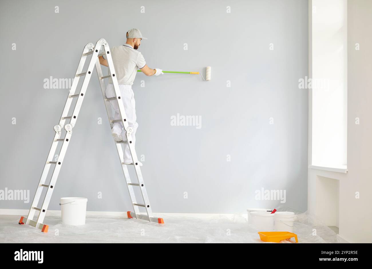 Professional Painter or Builder Painting Wall with Roller During ...