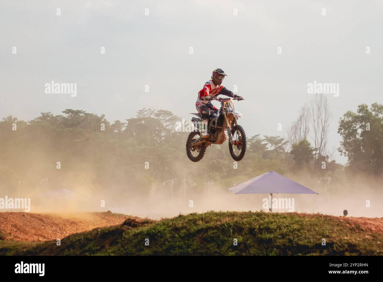 PUTRAJAYA, MALAYSIA - Sept 24, 2022 : A motocross competition unfolds on a dusty track ...